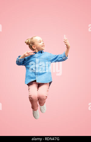 Young scared surprised caucasian teen girl jumping in the air, isolated ...