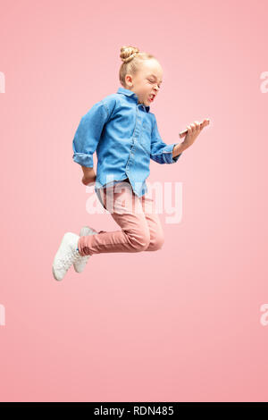 Young scared surprised caucasian teen girl jumping in the air, isolated ...