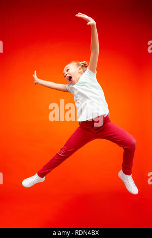 Young scared surprised caucasian teen girl jumping in the air, isolated ...