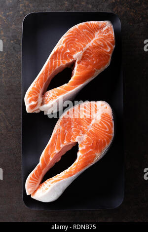 Fresh salmon fish at black top view Stock Photo - Alamy