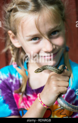 Portrait of a girl holding a snake Stock Photo - Alamy