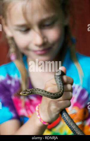 Girl holding snake Stock Photo - Alamy