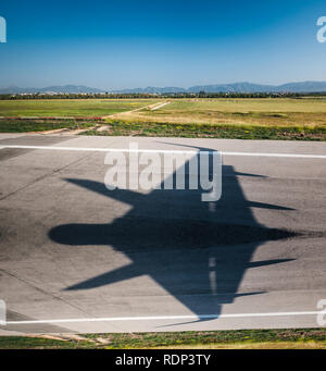 Abstract futuristic military plane shadow on the airport tarmac in ...