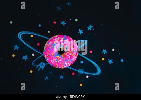 Space donut solar system with orbits and stars. Flat lay food ...