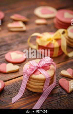 Board with tasty cookies for Valentine's Day celebration on table ...