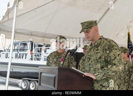 Capt. Bradley Andros, Commander, Task Force (CTF) 56, reads his orders ...