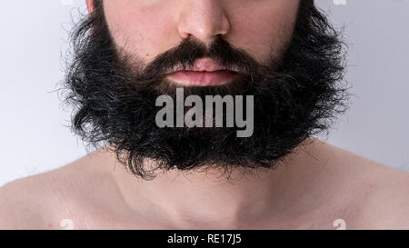 A part of a long ungroomed beard with long, messy and untrimmed hair ...