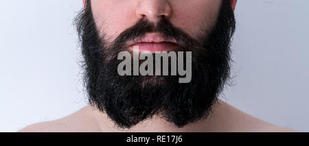 A part of a long ungroomed beard with long, messy and untrimmed hair ...