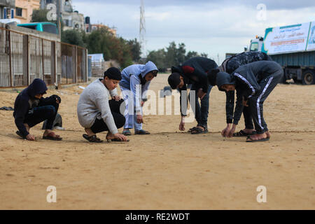 Children play the 'marbles', one of the most popular Palestinian game ...