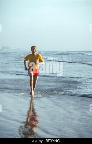 Lone man running on the sand through sandy desert Stock Photo - Alamy