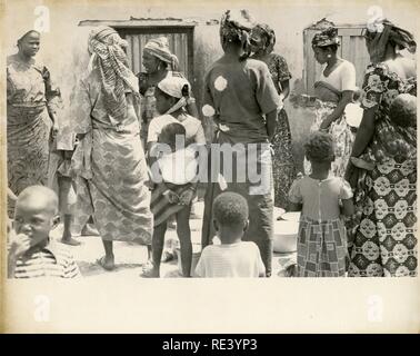WOMEN AND CHILDREN STANDING AROUND BUCKETS Stock Photo - Alamy