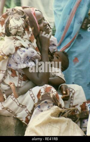 WOMAN WEARING AFRICAN GARB; HOLDING BABY Stock Photo - Alamy