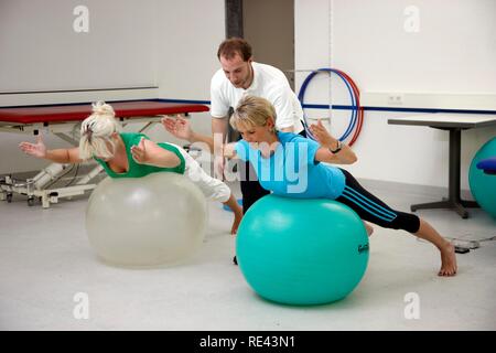 Physiotherapy exercises using exercise balls, physical therapy in a ...