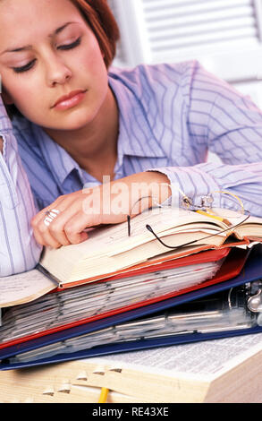 Pretty, young female student in front of a blackboard during class ...