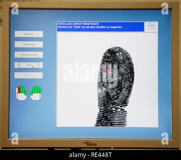 Fingerprints and handprints being recorded by digital scanner, physical ...