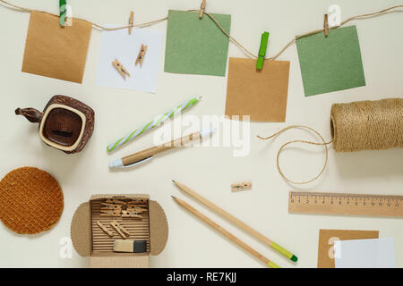 Flat lay of kraft paper stickers with clothespins, coffee and ...