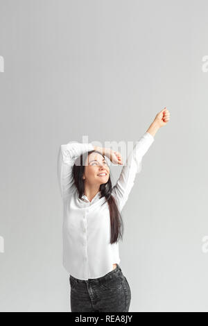 Freestyle. Woman standing isolated on grey with globe in one hand ...