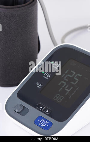 Screen of an electronic digital blood pressure monitor shows the upper ...