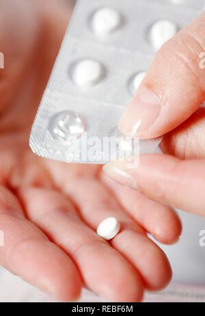 Hands taking tablet out blister Stock Photo - Alamy