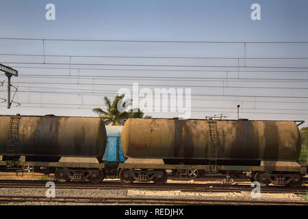 Cargo trains transporting liquid fuel at depot. Set of tanks with oil ...