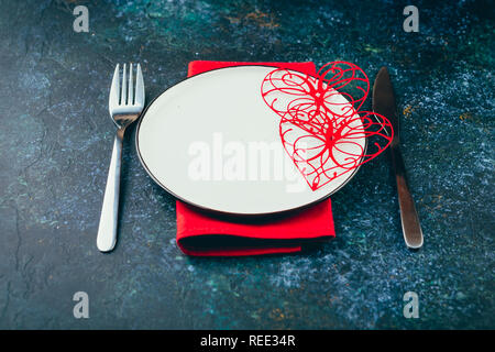 Table setting for Valentine's Day with hearts on red background Stock ...