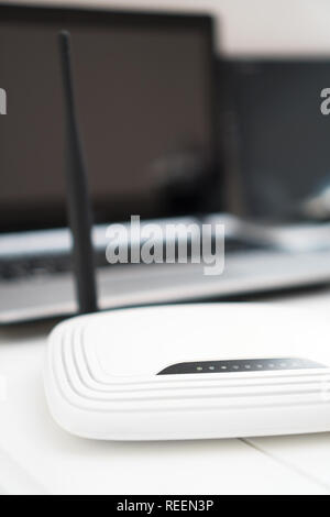 White wireless router standing on the table Stock Photo - Alamy