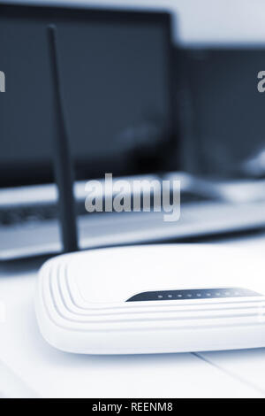 White wireless router standing on the table Stock Photo - Alamy