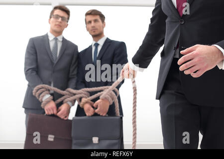 boss and rope-bound employees Stock Photo - Alamy