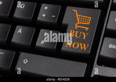 A key that says buy, concept online shopping Stock Photo - Alamy