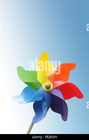 Colorful pinwheel against blue gradient background Stock Photo - Alamy
