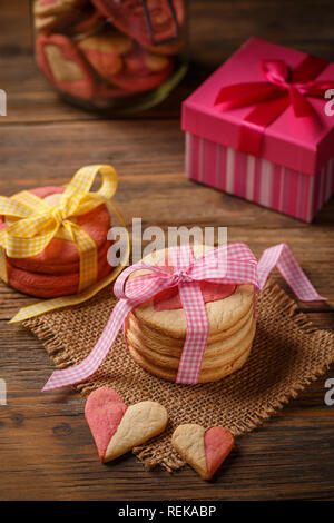 Tasty heart shaped cookies, calendar with date 14 FEBRUARY and gift on ...