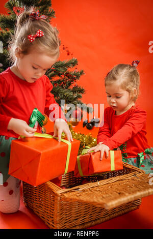 two beautiful girls together unpack gifts Stock Photo - Alamy
