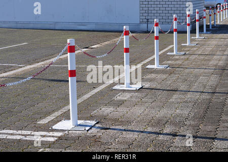 boundary at a parking lot with metal posts interconnected with chains ...