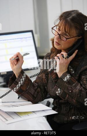 Secretary in an office on the telephone Stock Photo - Alamy