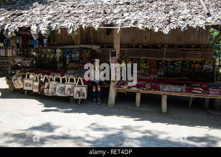 person at a Huts in Hmong Thailand village villagers sit sat sitting ...