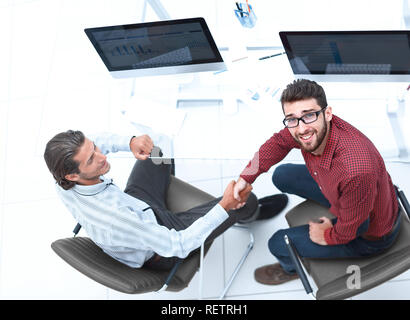handshake of the staff over a Desk Stock Photo - Alamy