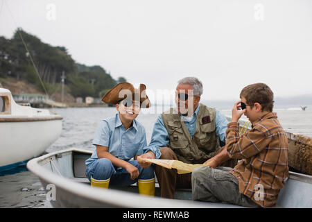 Father in a rubber boat with his two sons having family fun Stock Photo ...