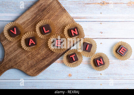 Valentine engraved in chocolate on colored background Stock Photo - Alamy