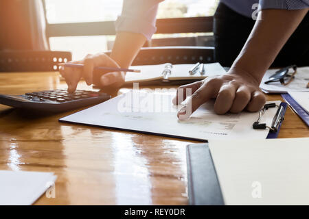 Businessman work with financial report at wooden office desk with ...