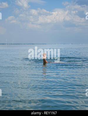 hand of the person about to drown in the middle of the ocean in very ...