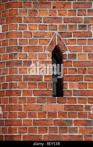 Narrow pointed window at a brick wall Stock Photo - Alamy