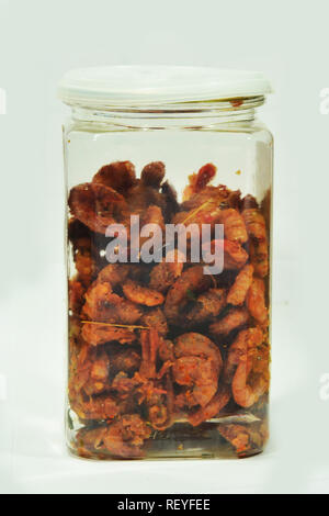 Dried shrimp or prawn in a glass bowl isolated on dark background used ...