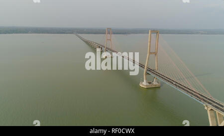 suspension bridge over madura strait with highway and car, surabaya ...