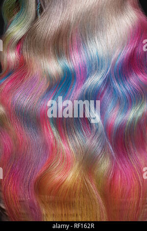 Beautiful girl with multi-colored hair and classic make-up and ...