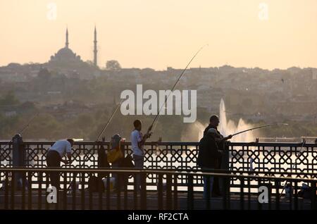 Fishermen angle at the Galata bridge during a hot day in Istanbul ...