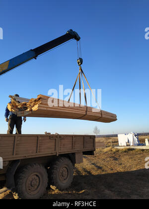 load boards supplied to the construction site with a crane, manipulator ...