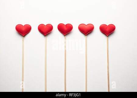 Red textile hearts on wooden sticks closeup. Valentines day background ...