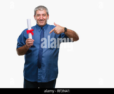 Handsome senior man holding degree over isolated background very happy ...