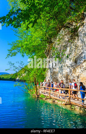 Tourists enjoy at the Plitvice Lakes National Park in Croatia, on ...