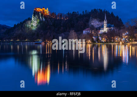 Lake Bled. Atmosphere of Christmas. Lights and reflections at night ...